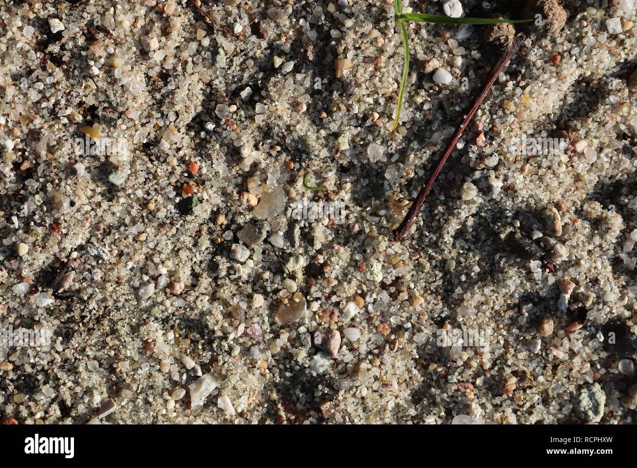 Close up high resolution surface of sand with footprints on the ground ...