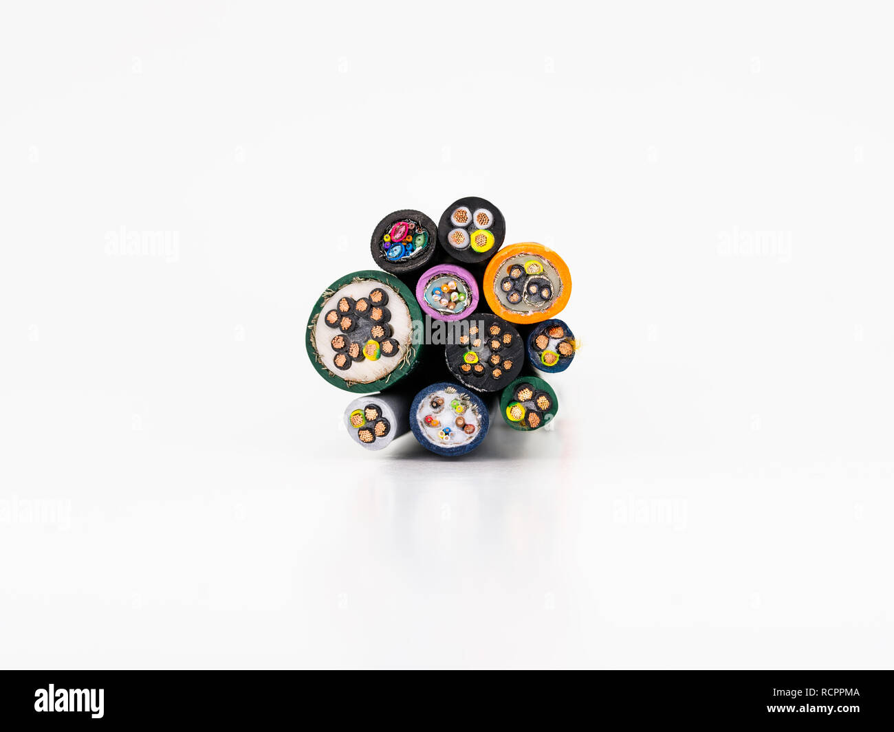 Cross-section of various electric cables, isolated on a white ...