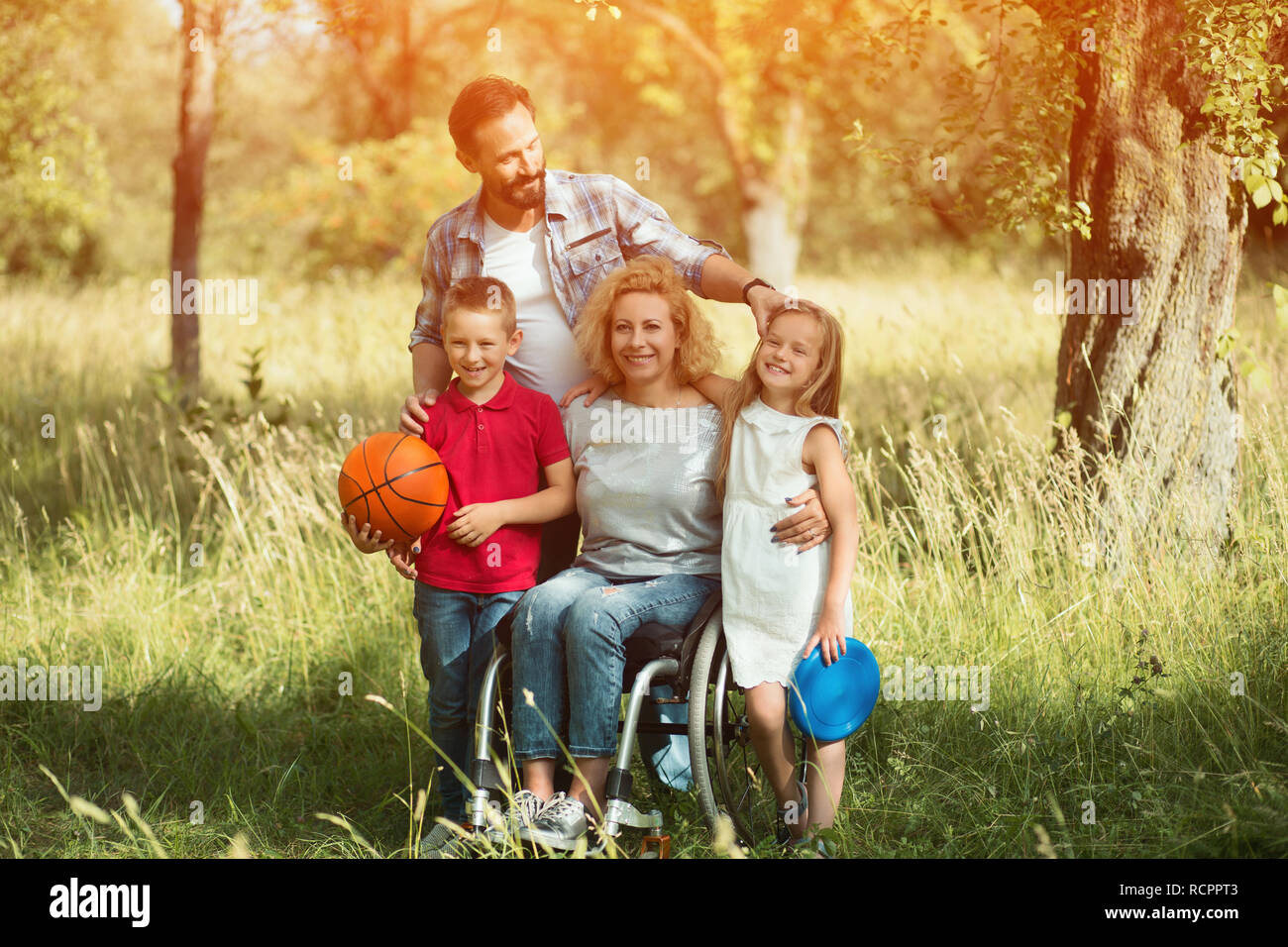 Family portrait. Woman in a wheelchair with her family outdoors Stock ...