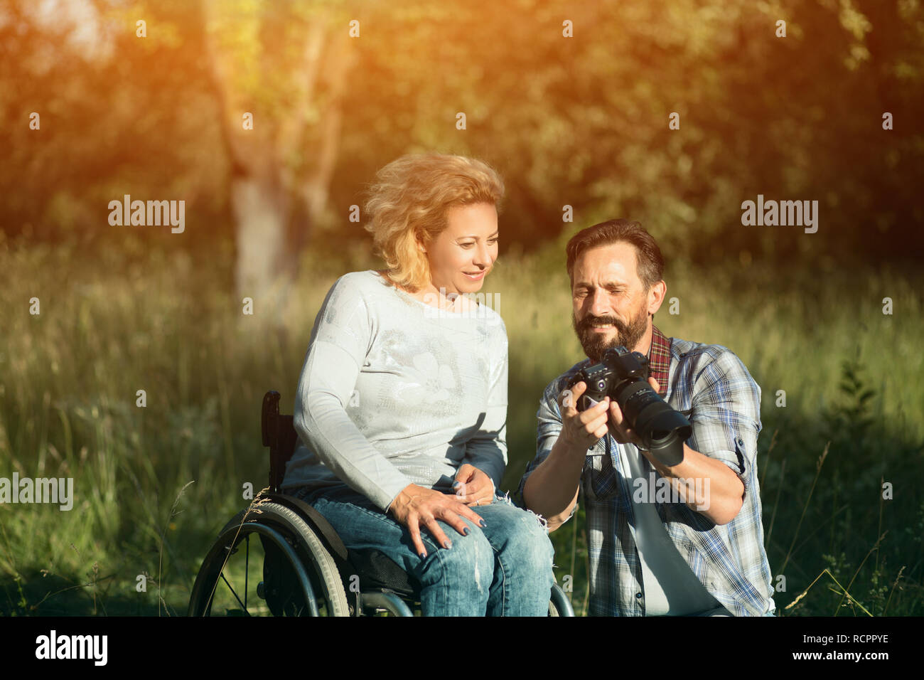 Disabled woman look on the taken photos on camera Stock Photo - Alamy