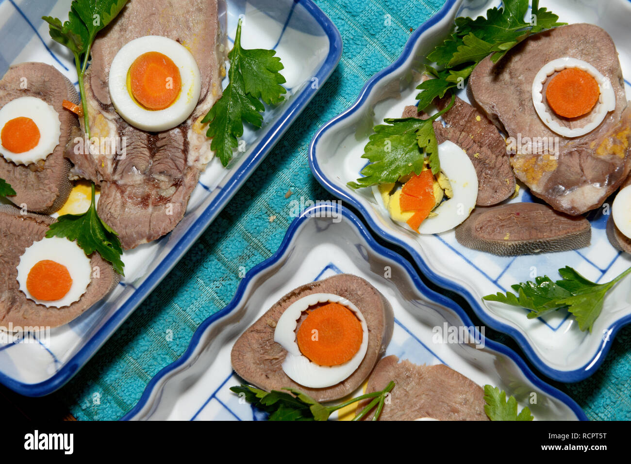 Close-up ingredients for jellied tongue that are arranging in ...