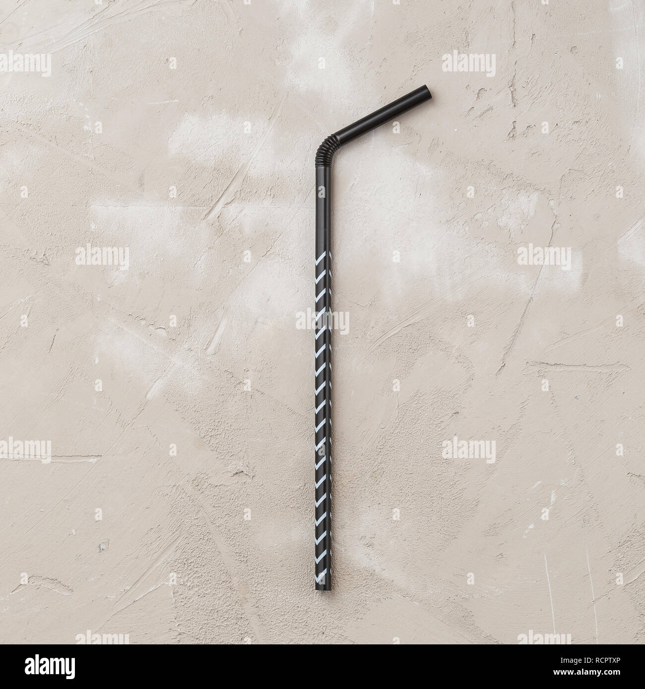One use plastic disposable drinking straw on concrete background ...