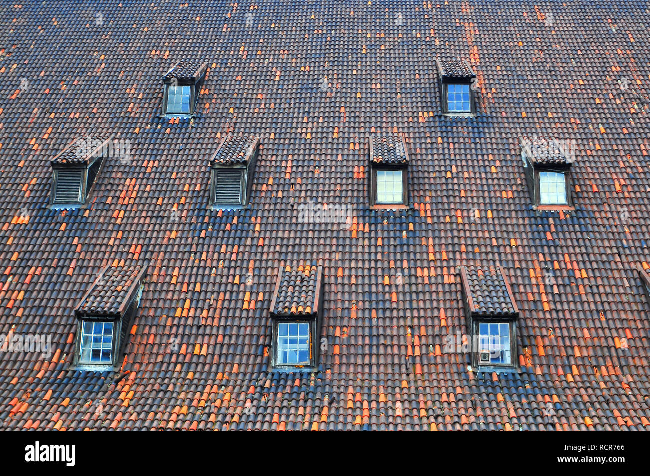 Clay tiles roof and windows on a very old building Stock Photo - Alamy