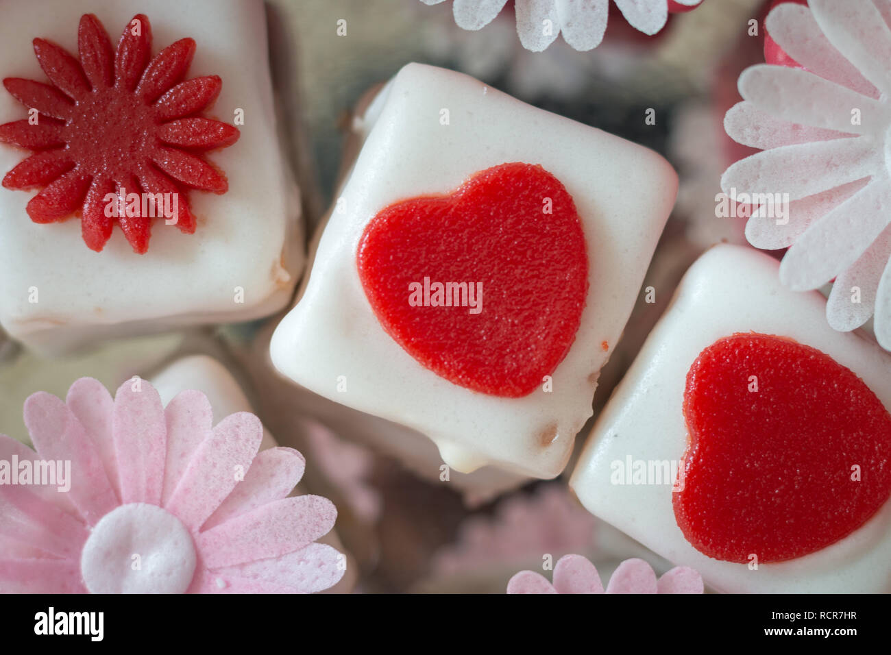 Colorful petit fours with flower decoration Stock Photo - Alamy