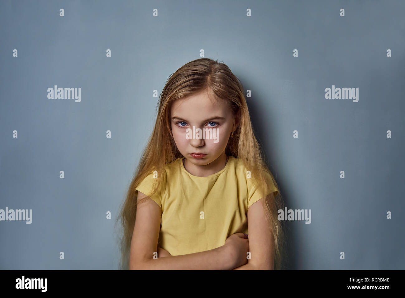 portrait of a girl, shows emotions on the face, on a blue background ...
