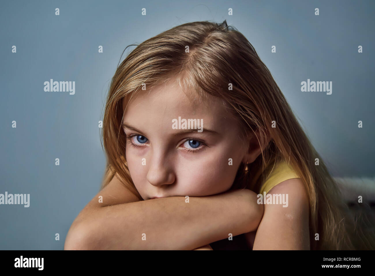 portrait of a girl, shows emotions on the face, on a blue background ...