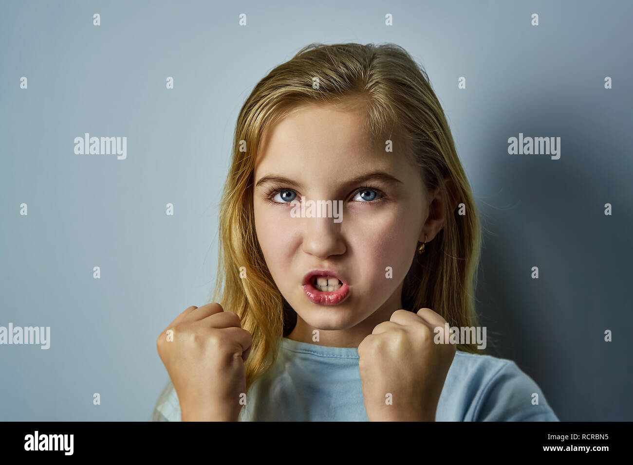 portrait of a girl, shows emotions on the face, on a blue background ...