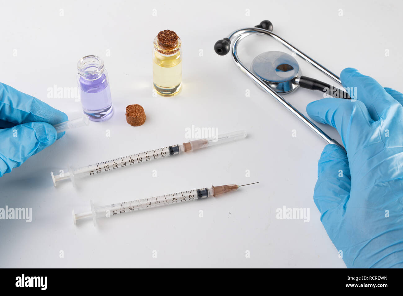 A small syringe, medicine and doctor's hands in gloves. Utensils ...