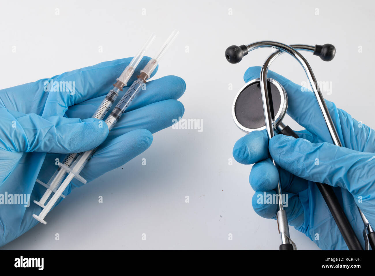 A small syringe, medicine and doctor's hands in gloves. Utensils ...