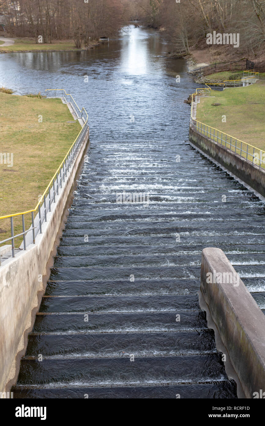 A small dam on a small river. Water dam in central europe. Season ...