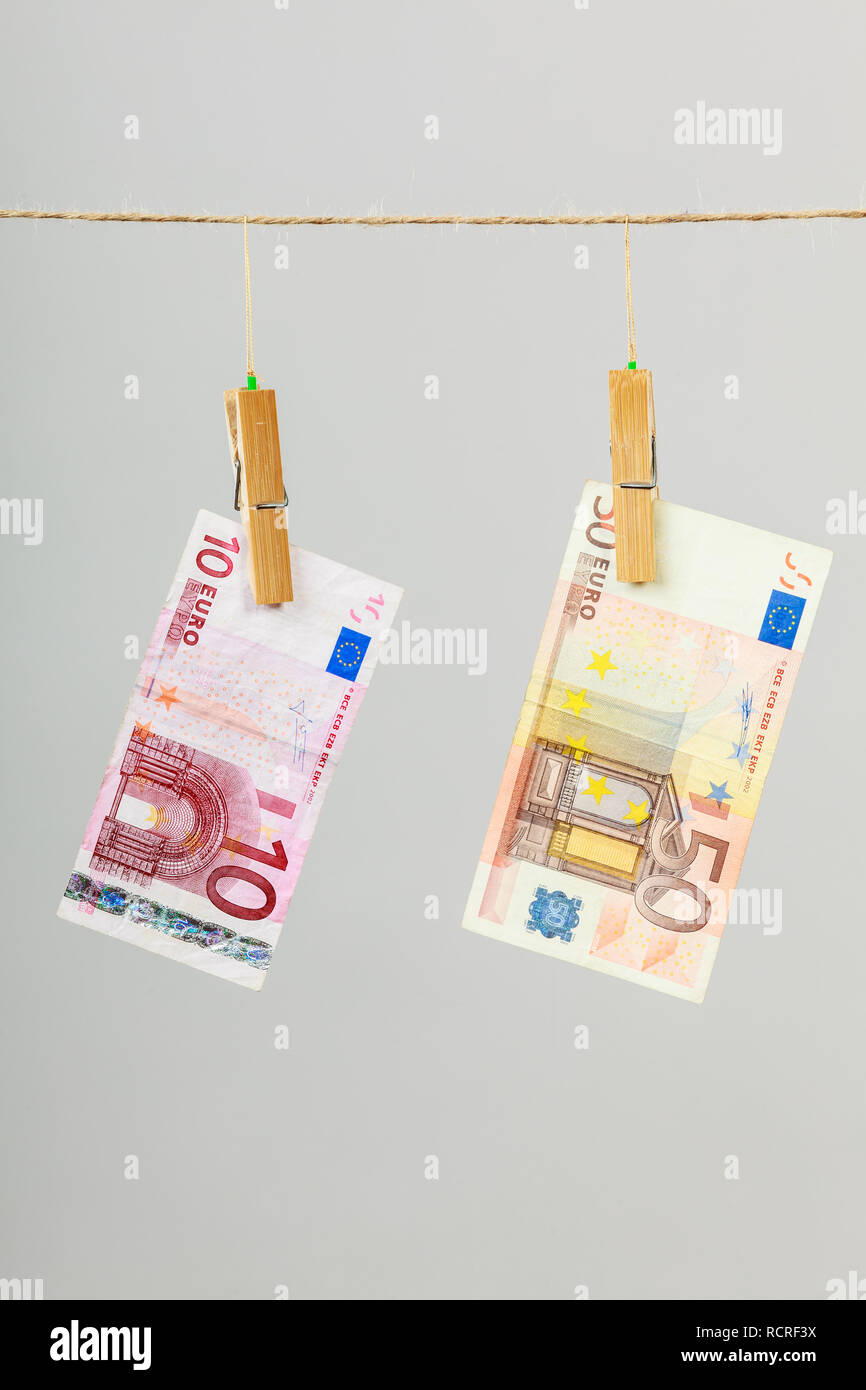 Banknotes cash money hang on laundry line on gray grey background Stock ...