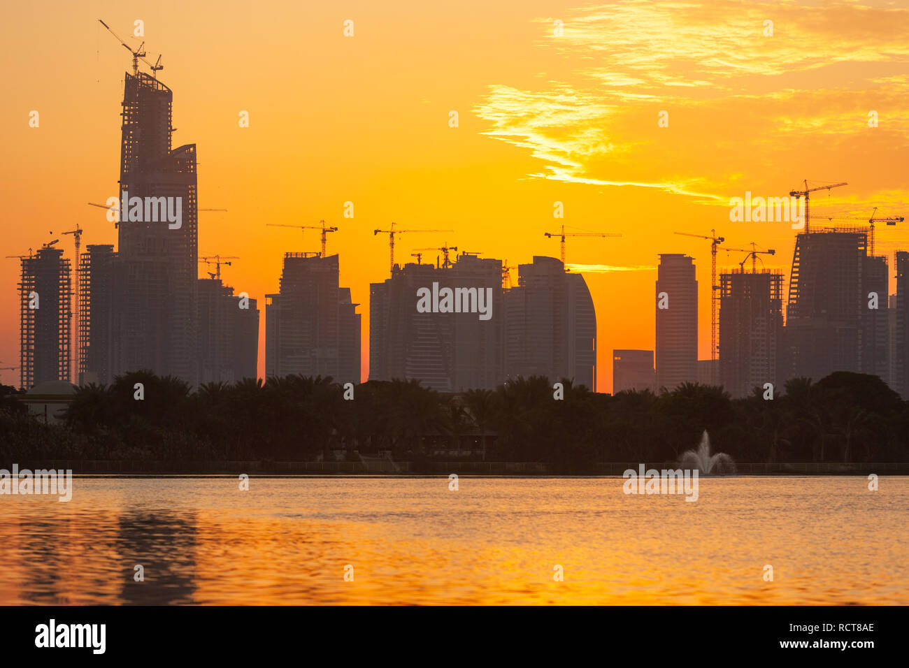 Construction at sunset during the building boom in Dubai Stock Photo ...