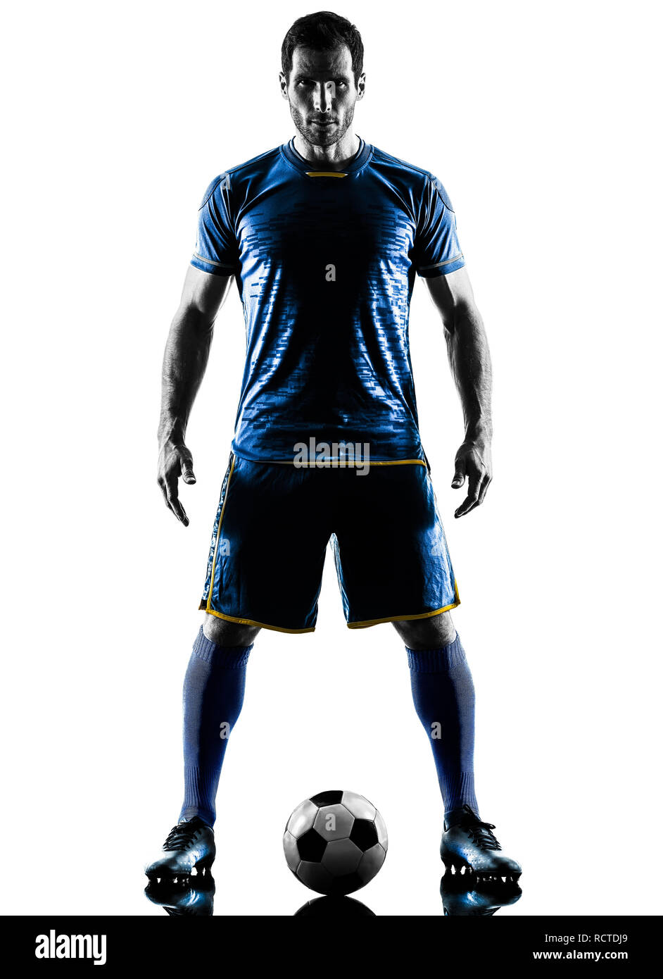 one caucasian soccer player man standing in silhouette isolated on ...
