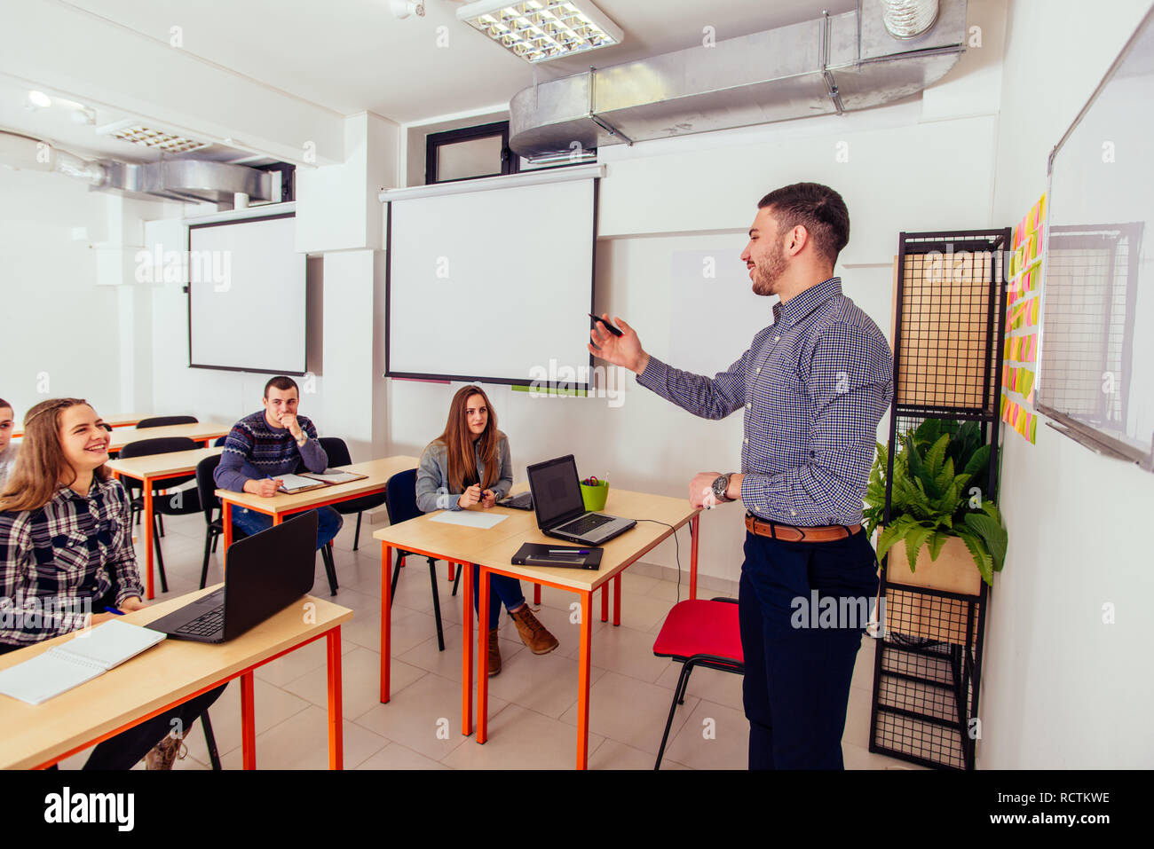 Group of teens are on class, smiling and talking Stock Photo - Alamy