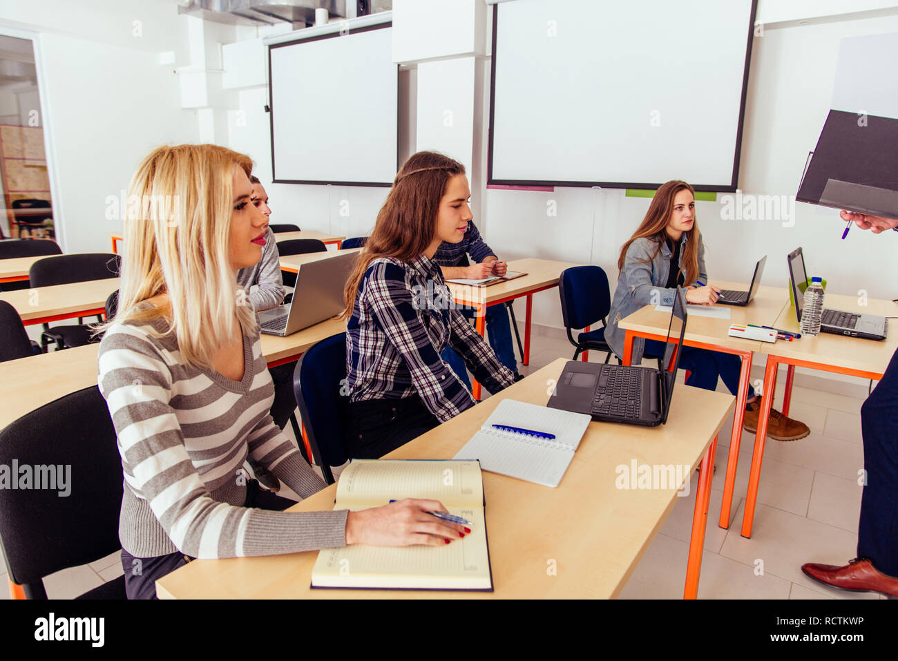Young students are in classroom, they are listening carefully Stock ...