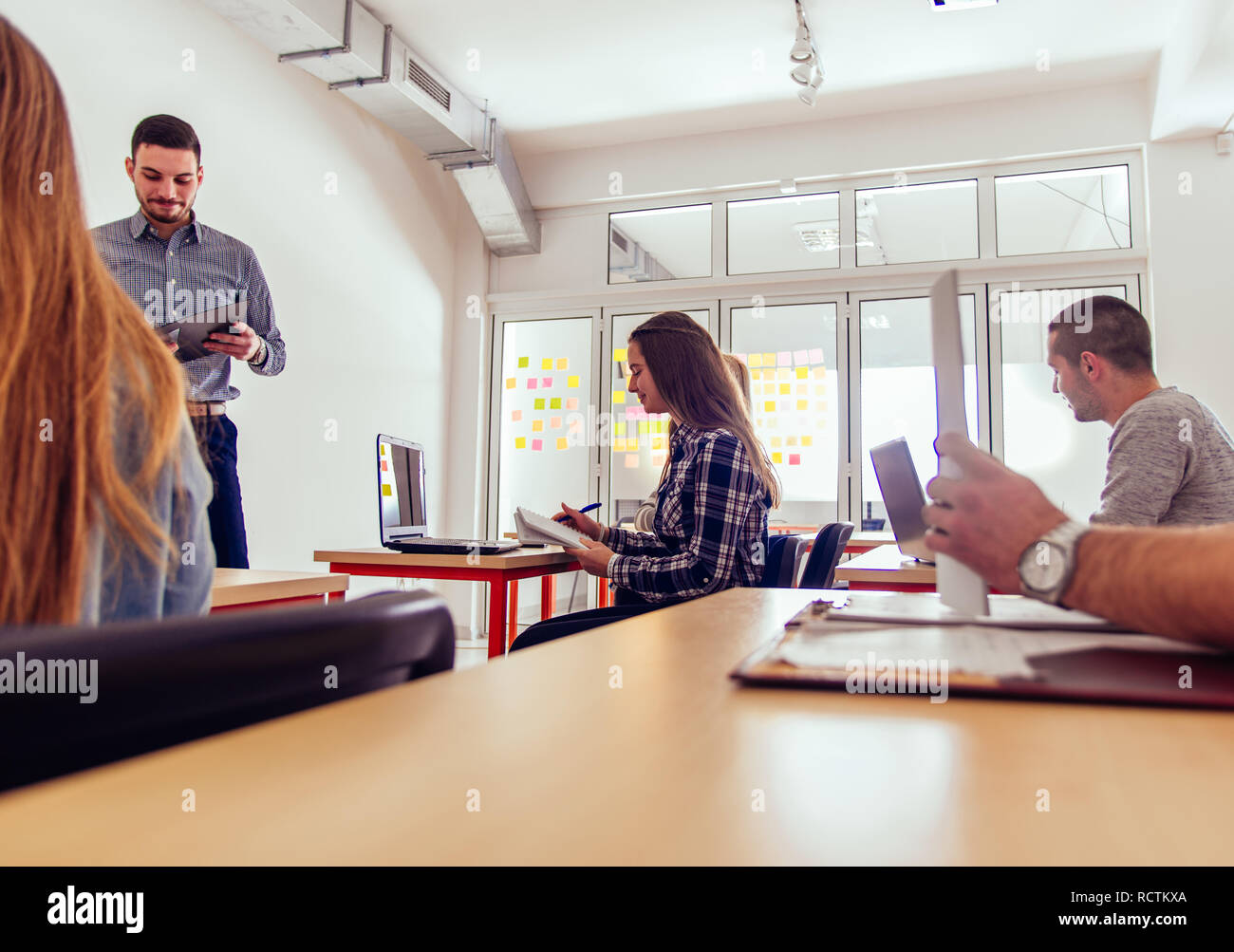 Modern students are reading in the classroom Stock Photo - Alamy