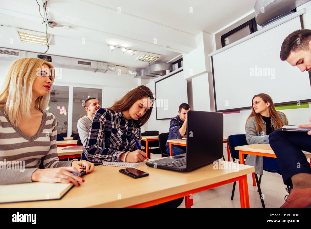 Modern students are reading in the classroom Stock Photo - Alamy