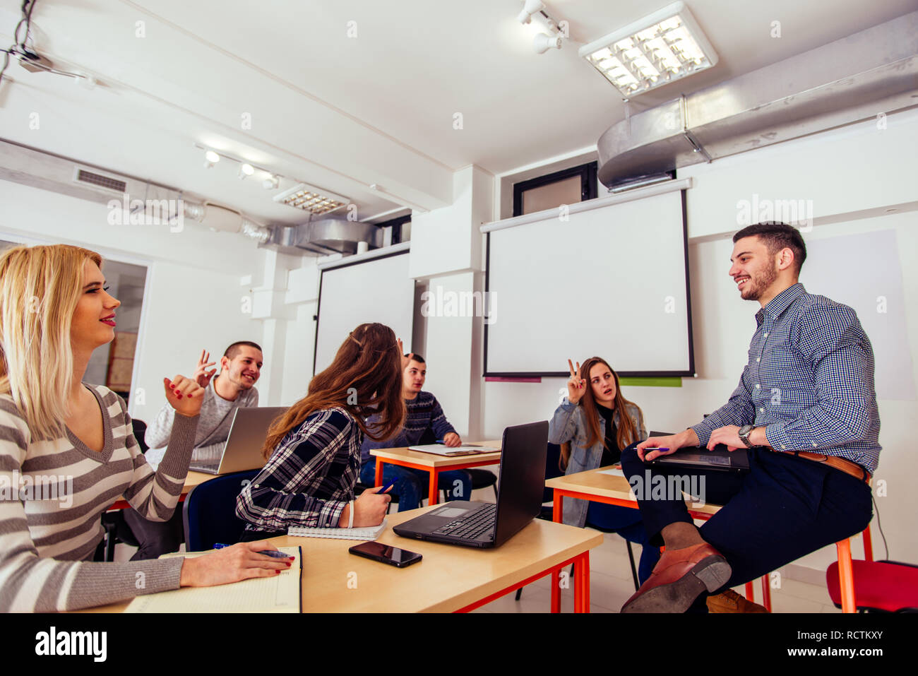 Young students are on class and listening carefully their teacher Stock ...
