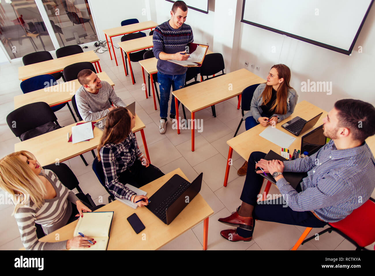 Students sitting in the classroom and listening carefully to their ...