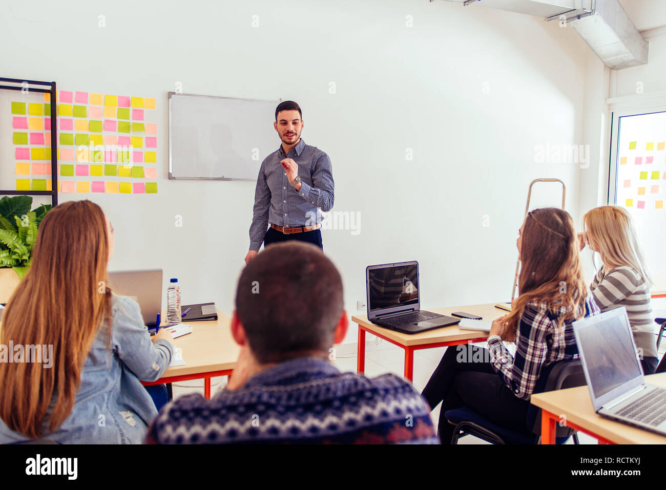 Young students are in classroom, they are listening carefully Stock ...