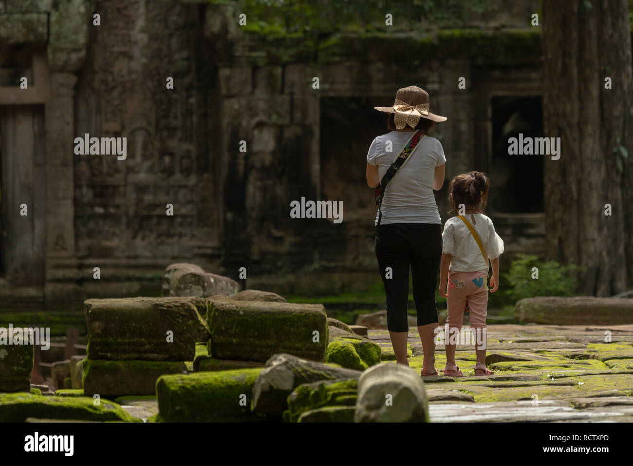 Mother and daughter stand on mossy flagstones Stock Photo - Alamy