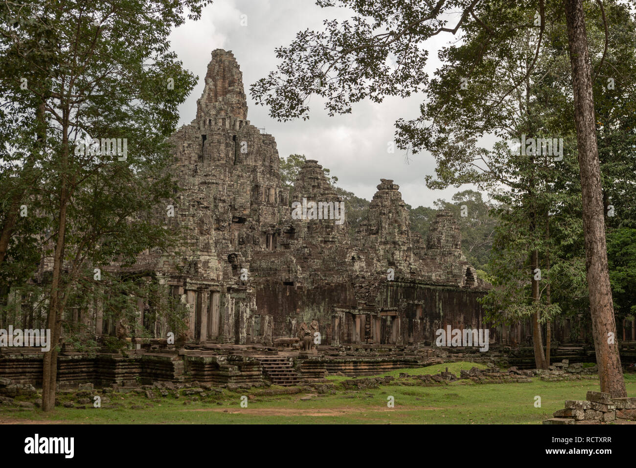 Ruined Bayon temple seen through the trees Stock Photo - Alamy