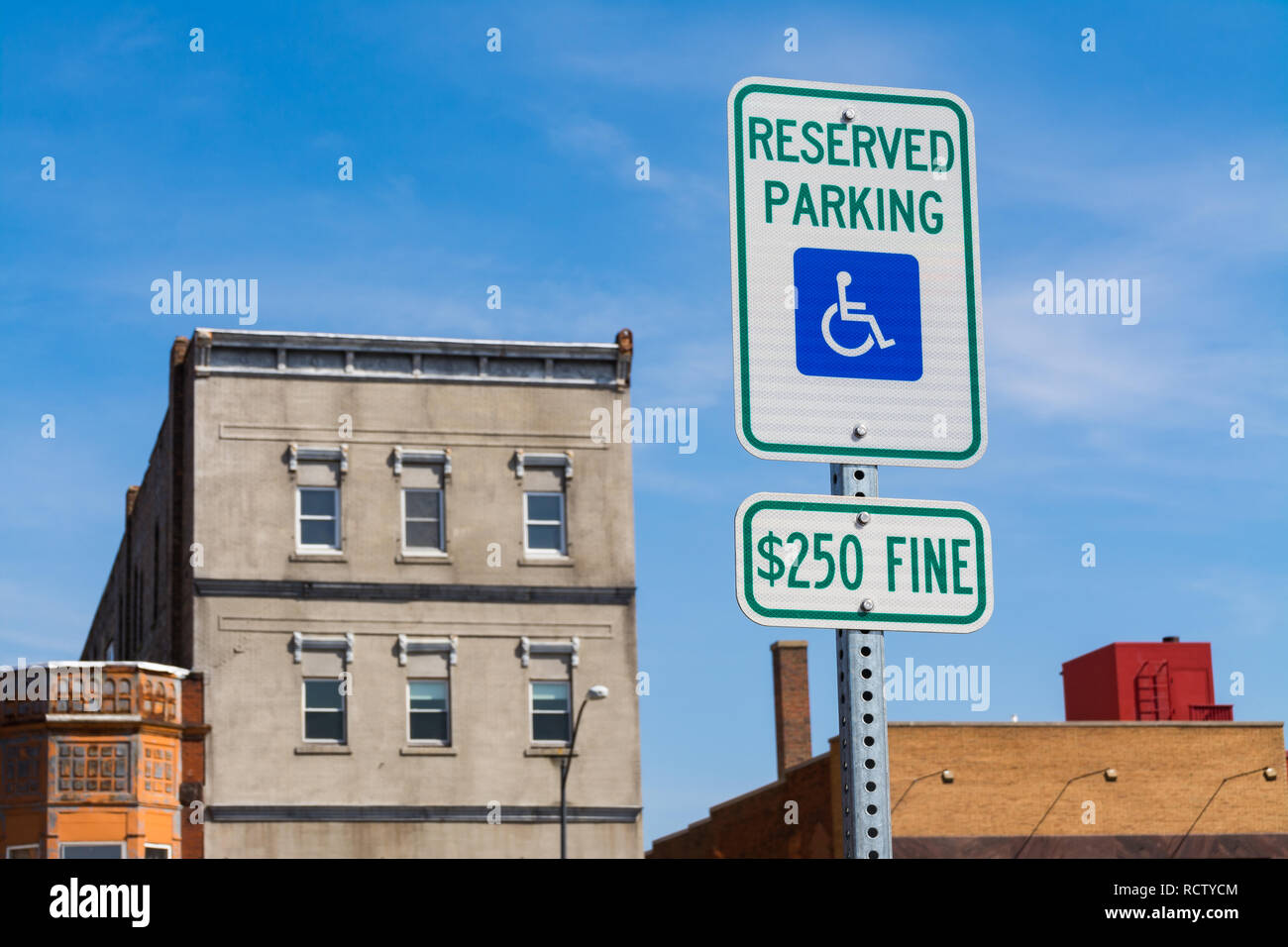 The "Reserved Parking for Disabled" sign with blue skies in the ...
