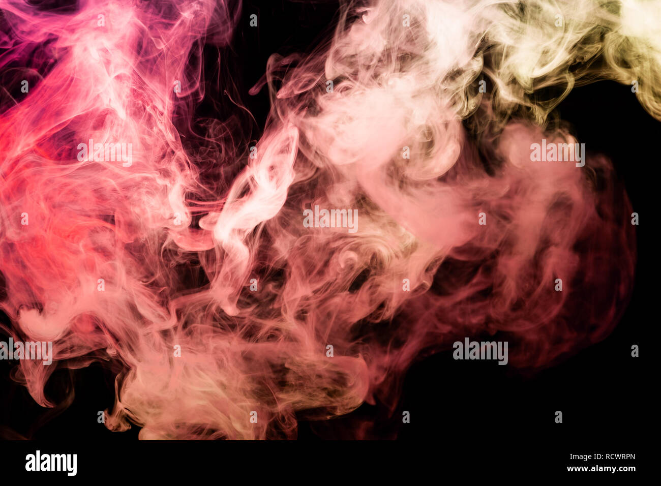 Thick yellow and red smoke on a black isolated background. Background ...