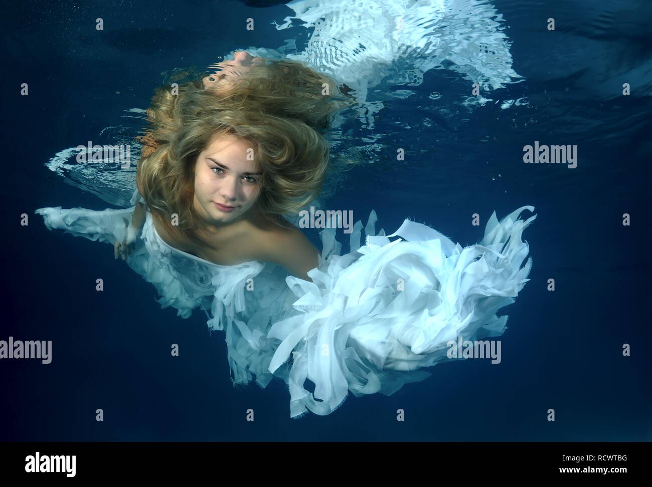 Woman presenting underwater fashion in a pool Stock Photo - Alamy