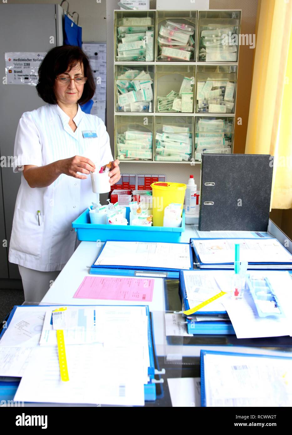 Nurse preparing the documents and medicine for patients in the nurse's ...