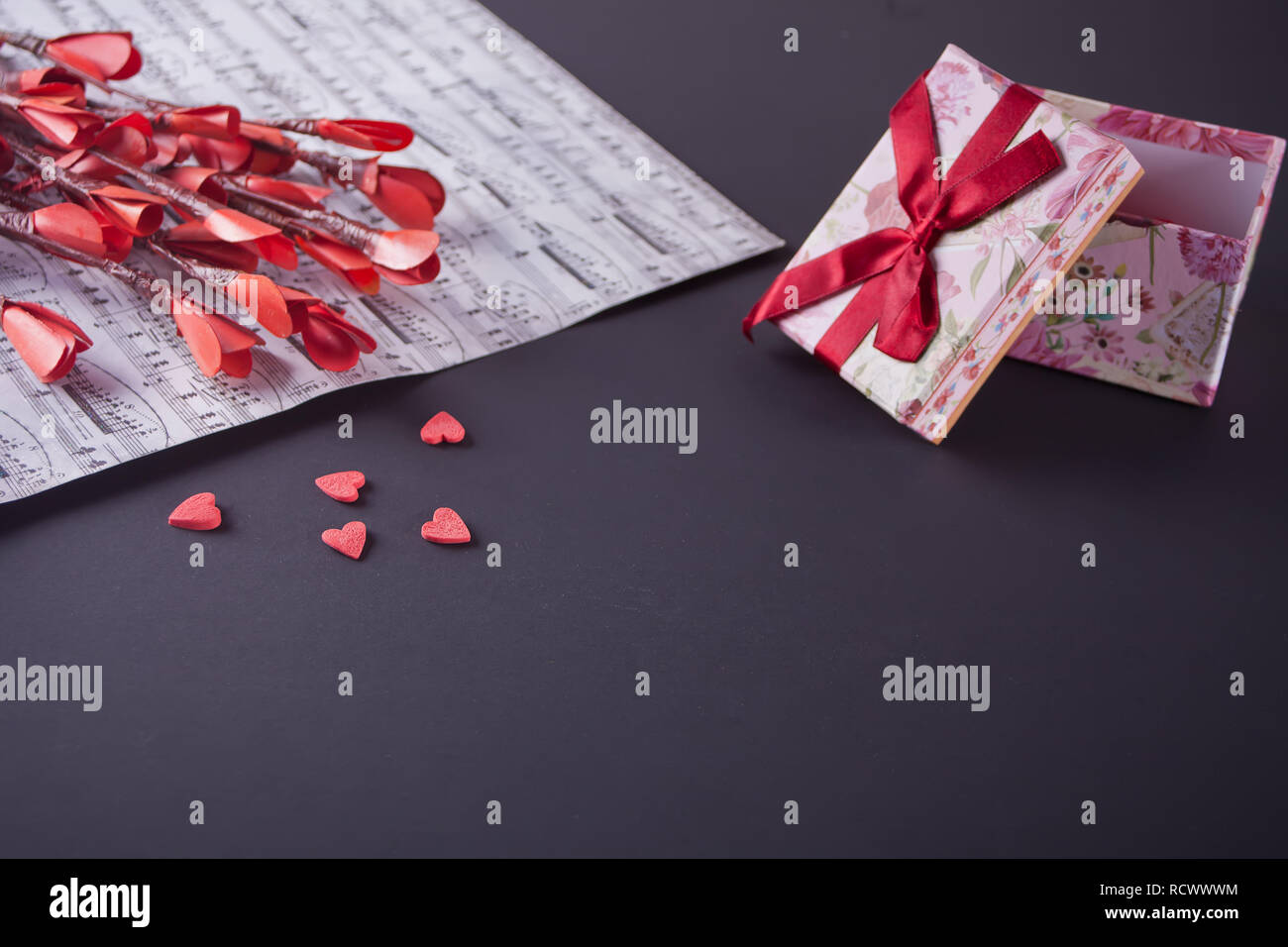 Valentines day concept with paper flowers, candy sweet hearts, gift box ...