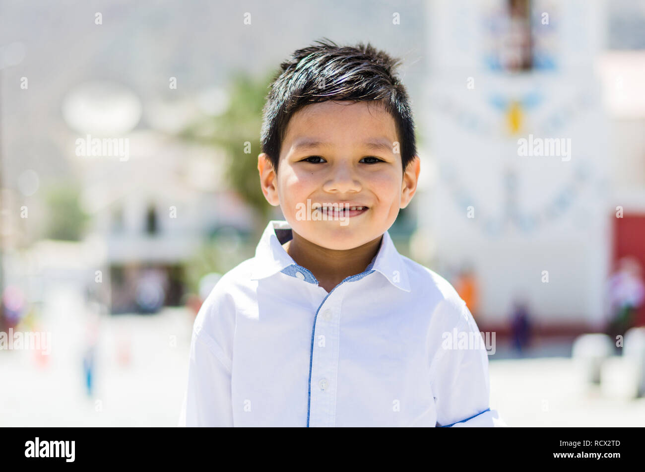 Boy in white shirt outdoors smiling without teeth Stock Photo - Alamy