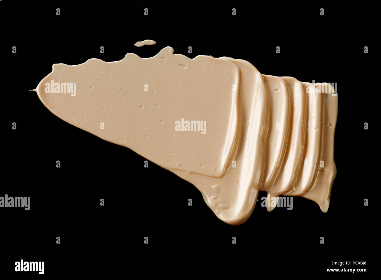 the texture of a foundation liquid. Black background Stock Photo - Alamy