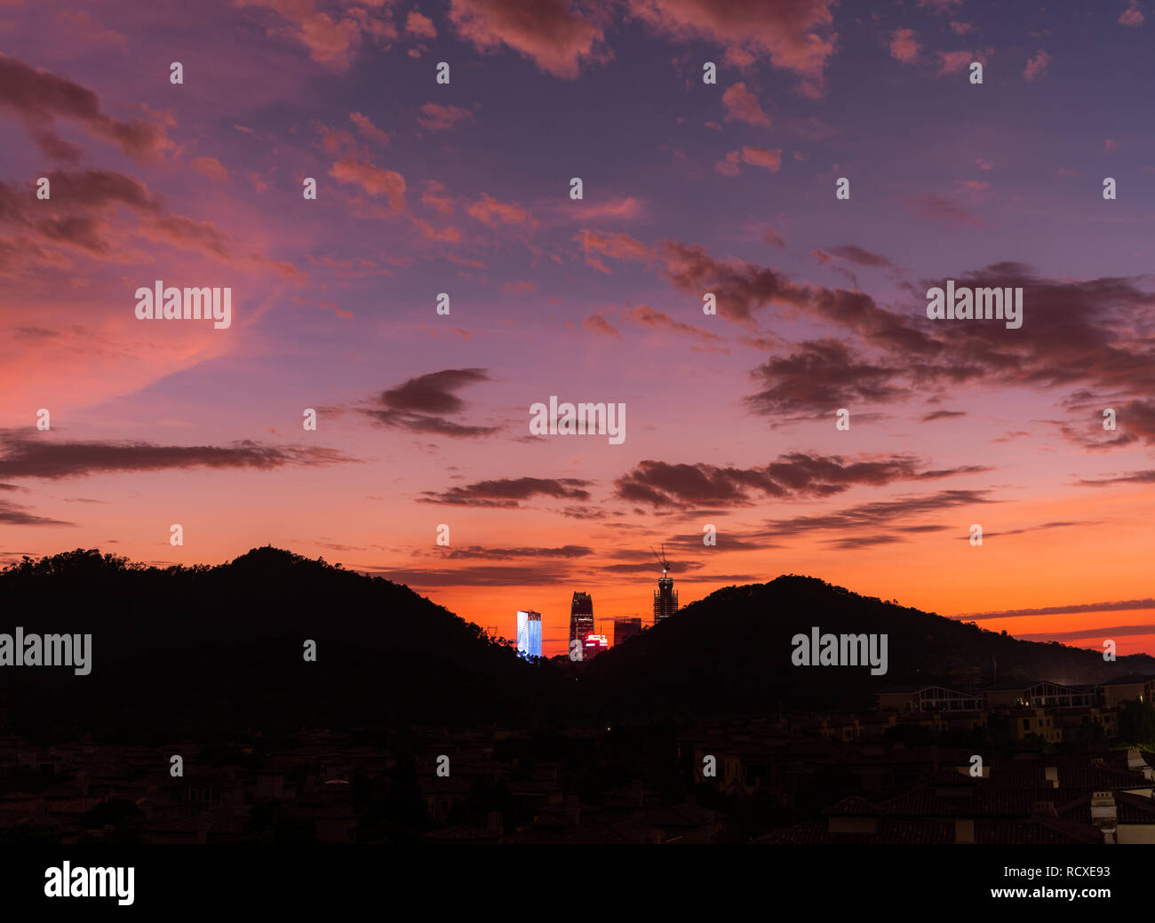 Sunset with buildings on the back and clouds Stock Photo - Alamy