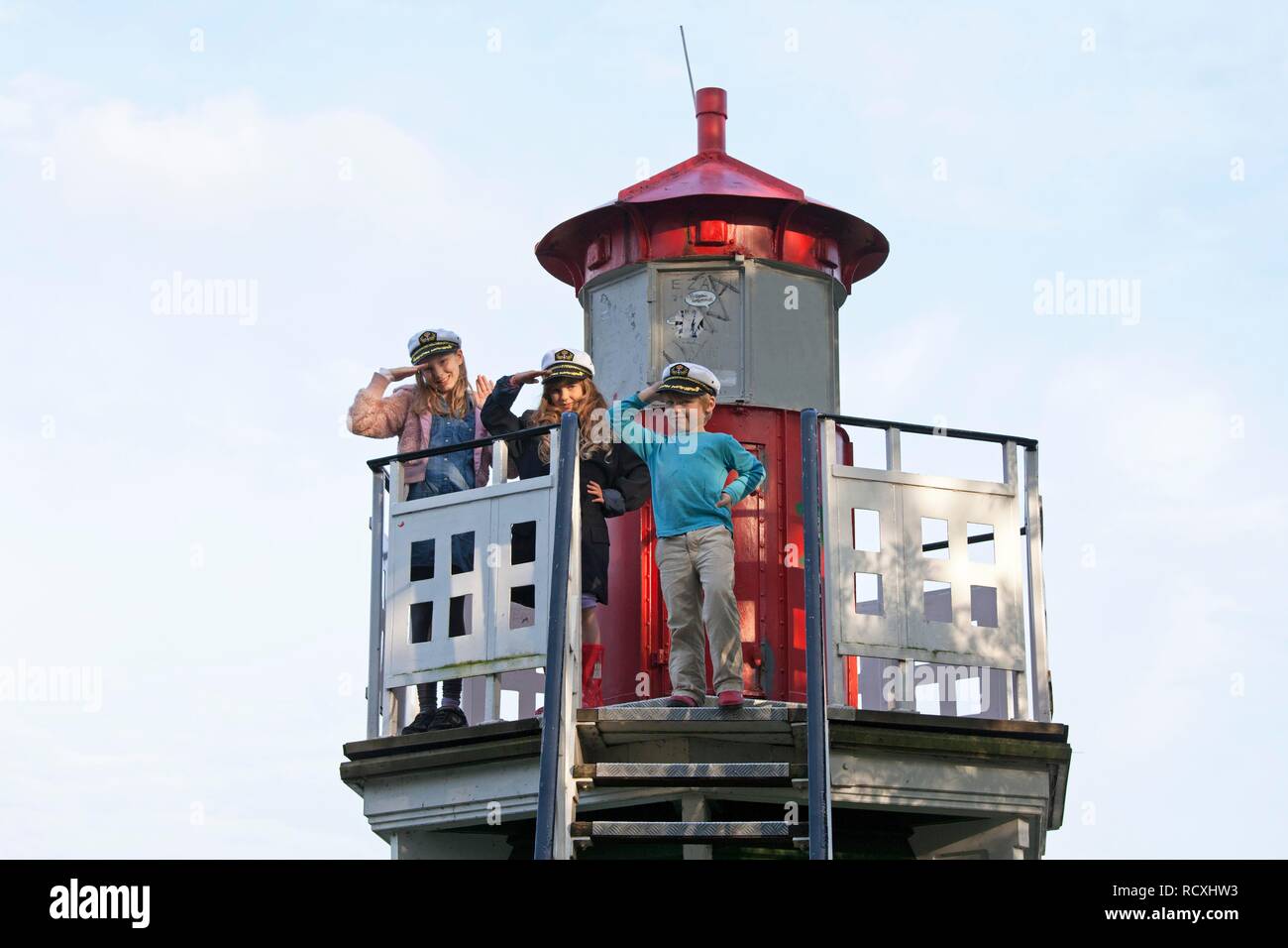 Children with captain's hats on Bunthaeuser Spitze lighthouse, Hamburg ...