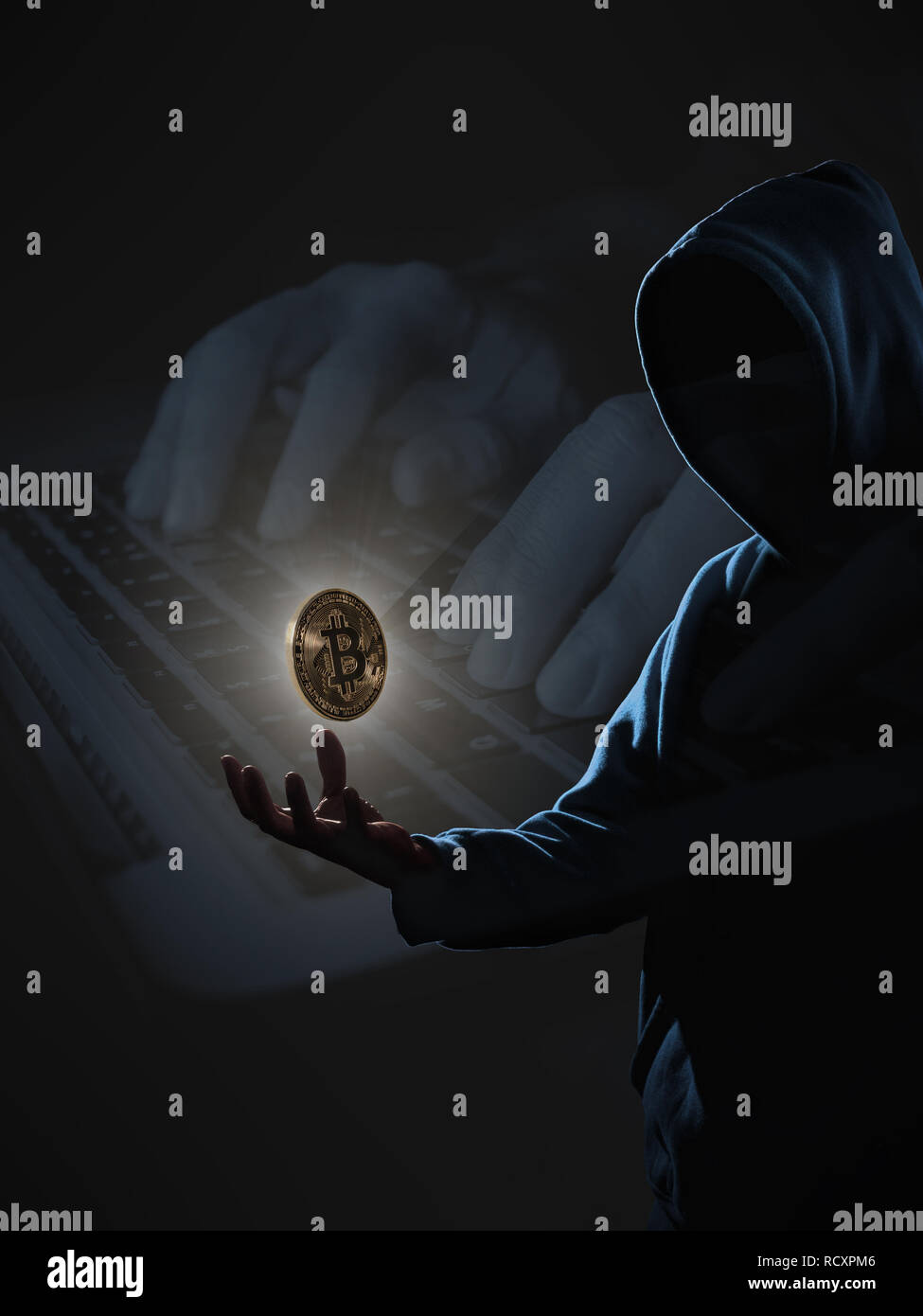 Golden Bitcoin floating above of hacker's hand in dark on hacker ...