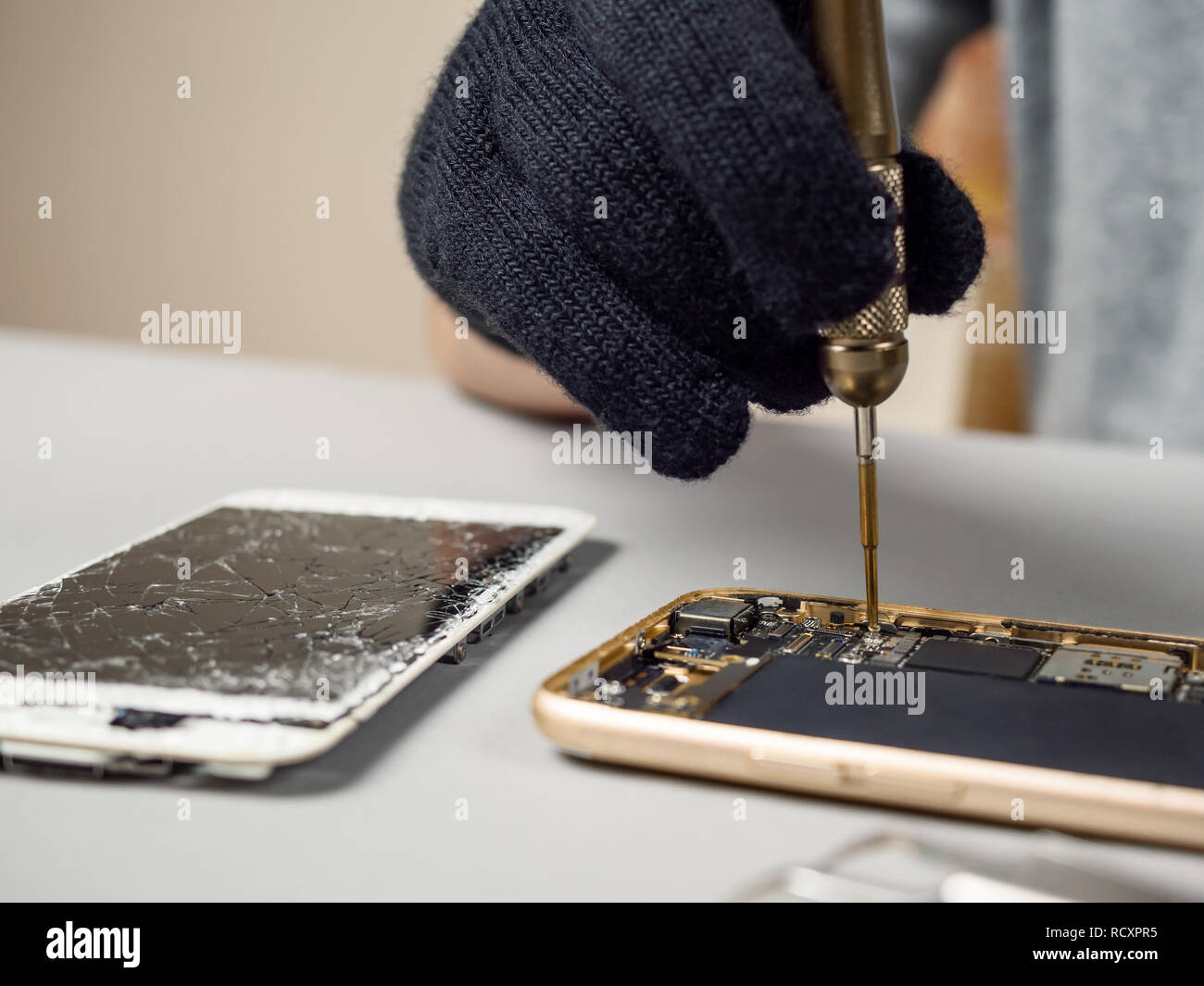 Technician or engineer disassembling components broken smartphone for ...