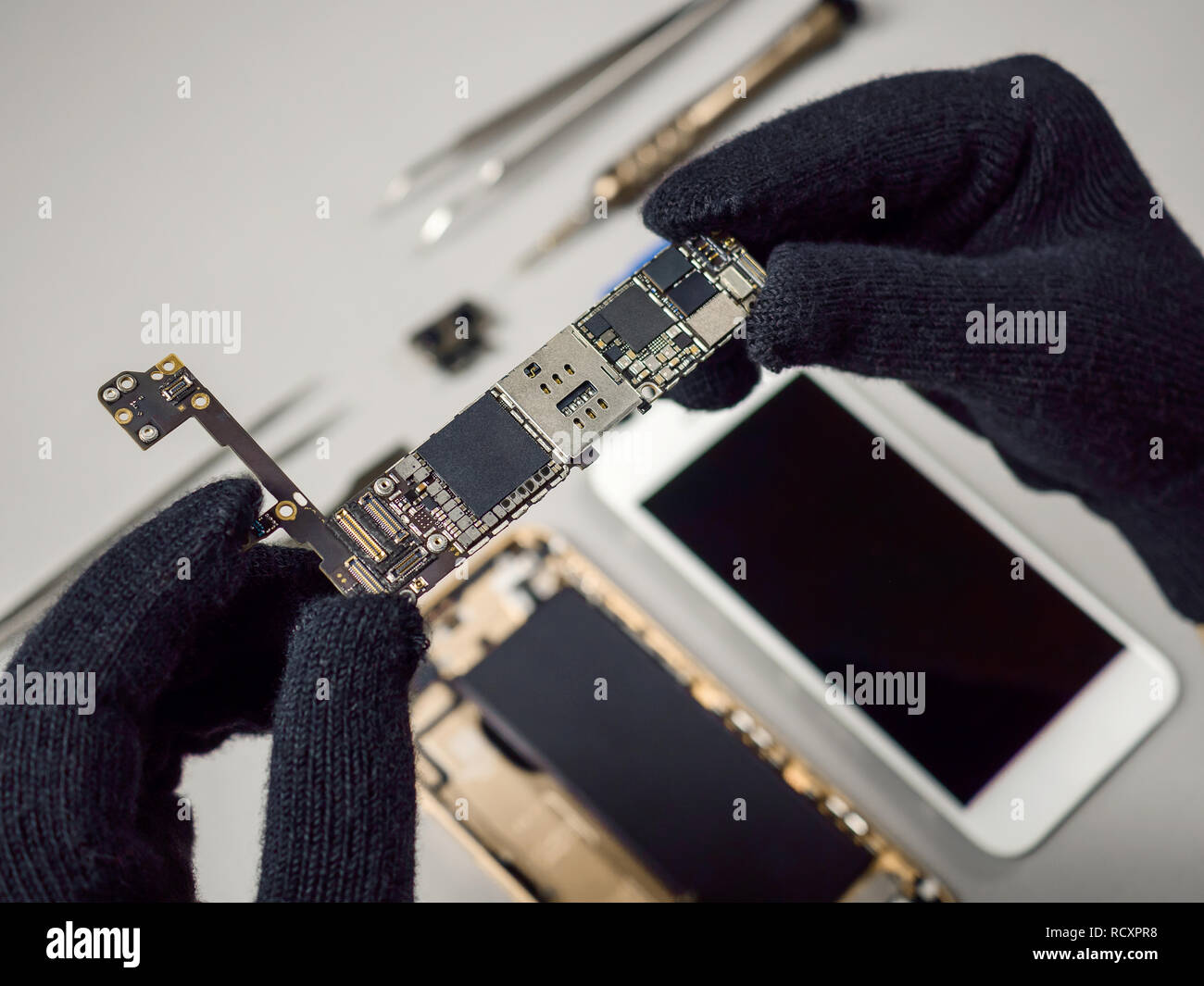 Technician or engineer disassembling components broken smartphone and ...