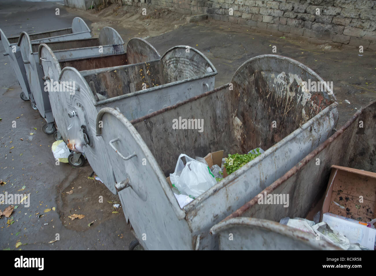 Old green dumpsters on the street. Household waste in the city. Old ...