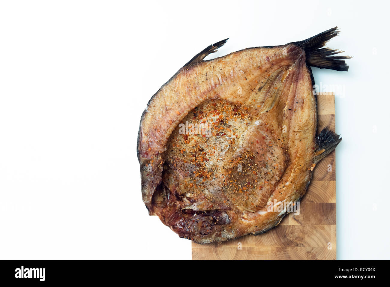 Close up horizontal view of smoked fish fillets with seasoning on ...