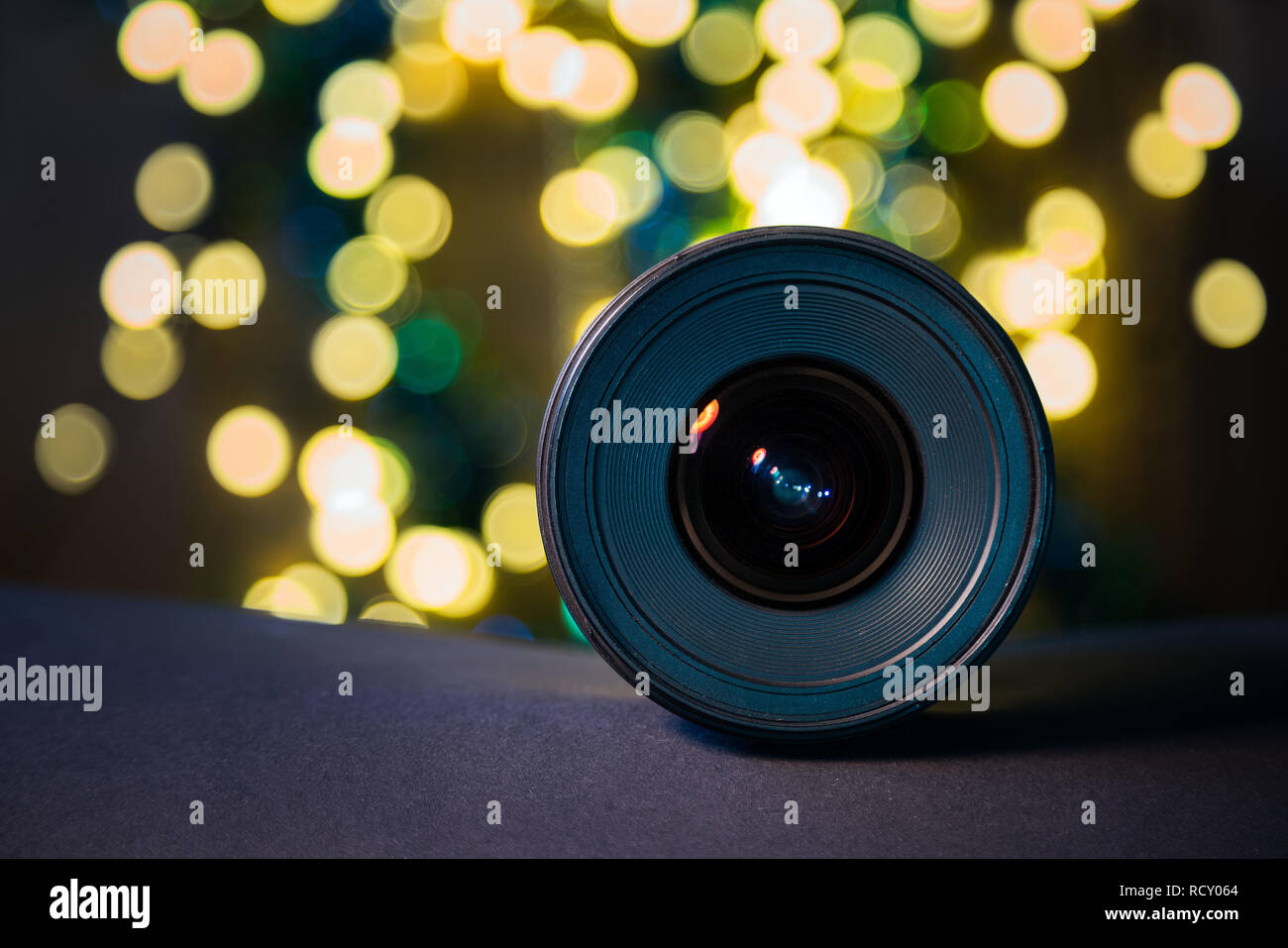 Close up of camera lens front element with defocused bokeh balls in the ...