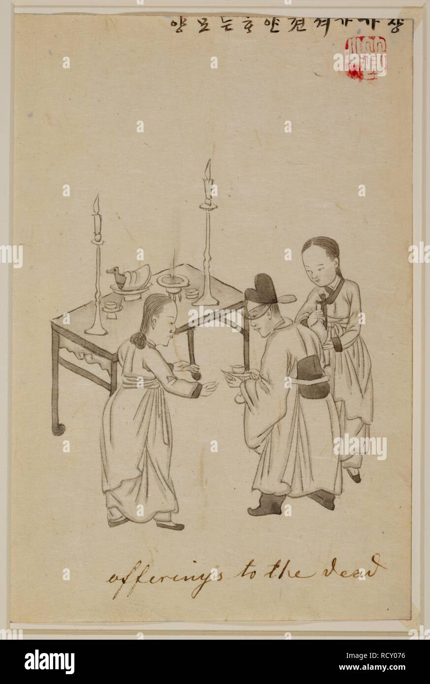 'Offerings to the dead.' Three people performing a religious ritual ...
