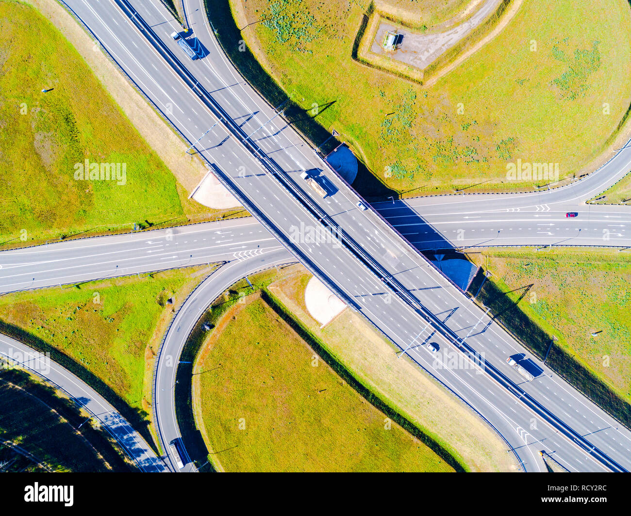 Aerial view of highway in city. Cars crossing interchange overpass. Highway interchange with ...