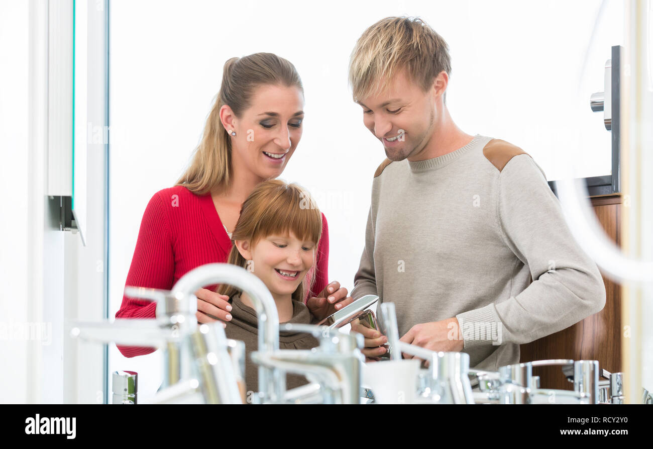 Portrait of a happy family together in the interior of a modern shop ...