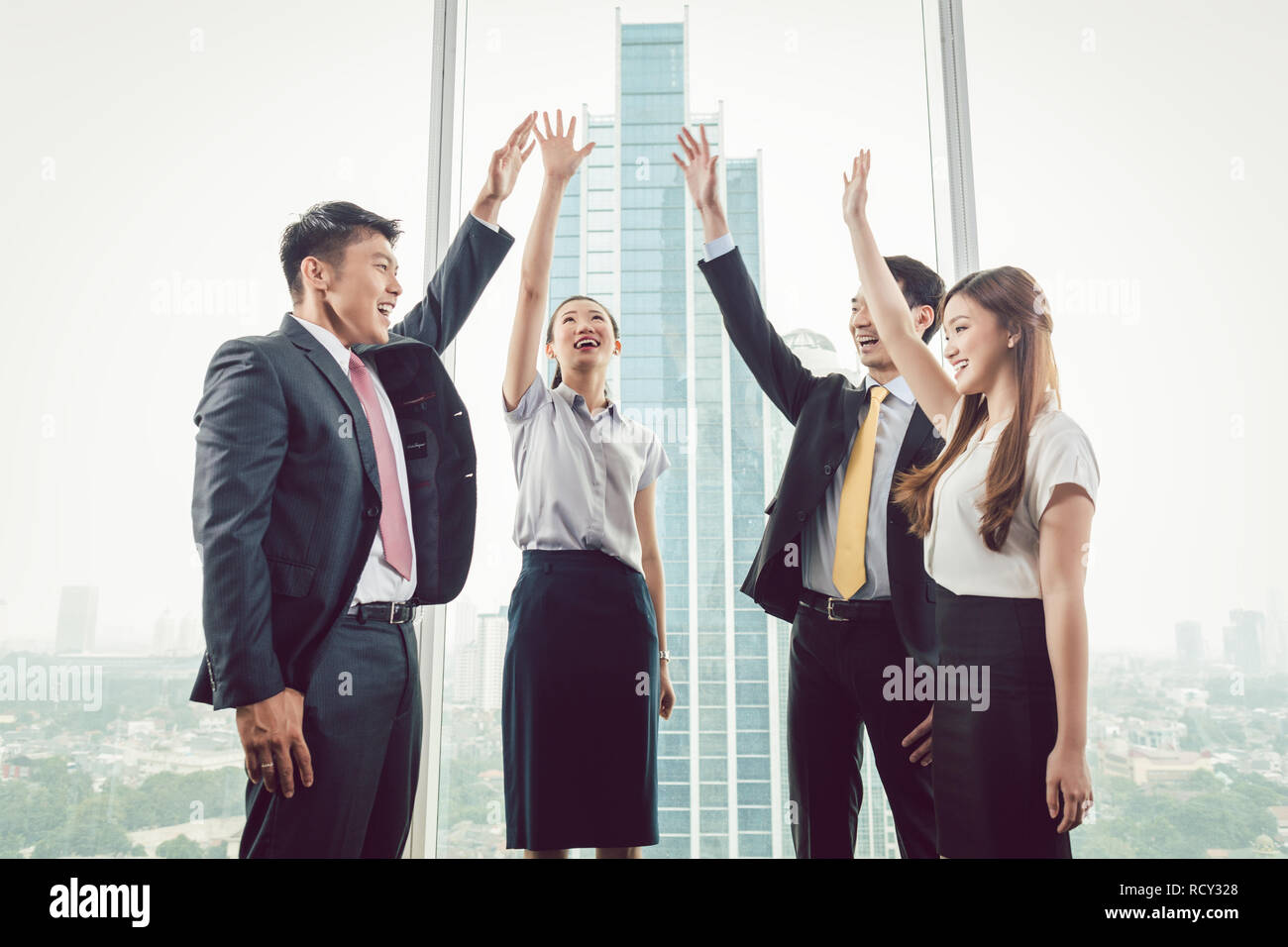 Group of businesspeople raising their hands Stock Photo - Alamy