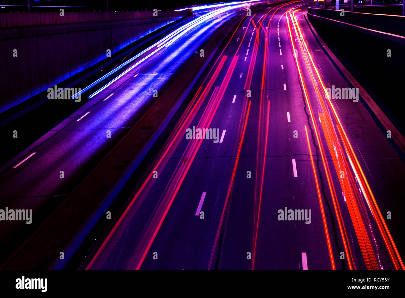 Cars light trails on a curved highway at night. Night traffic trails ...