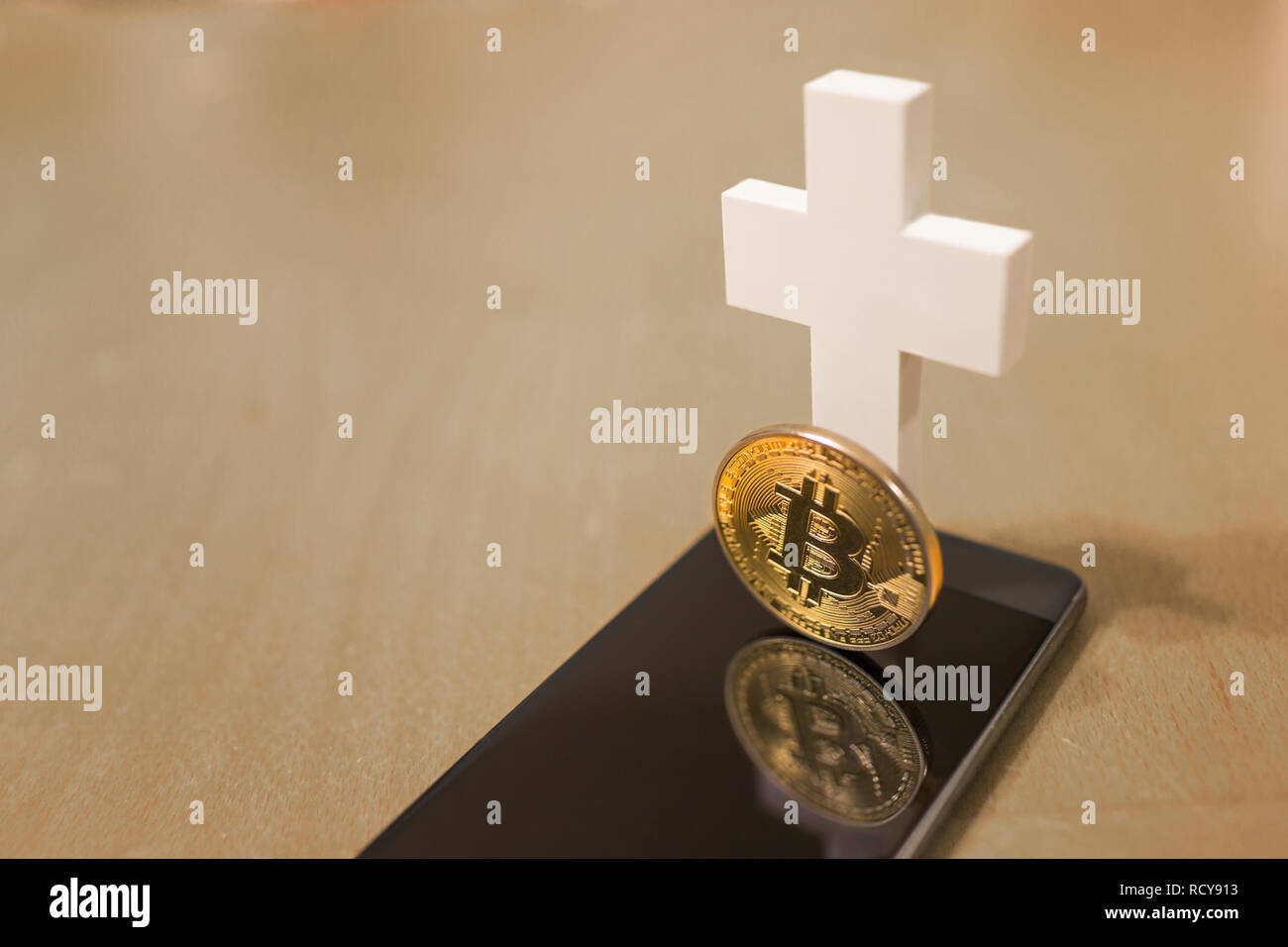 Dead Bitcoin concept with white cross and smartphone as grave Stock ...