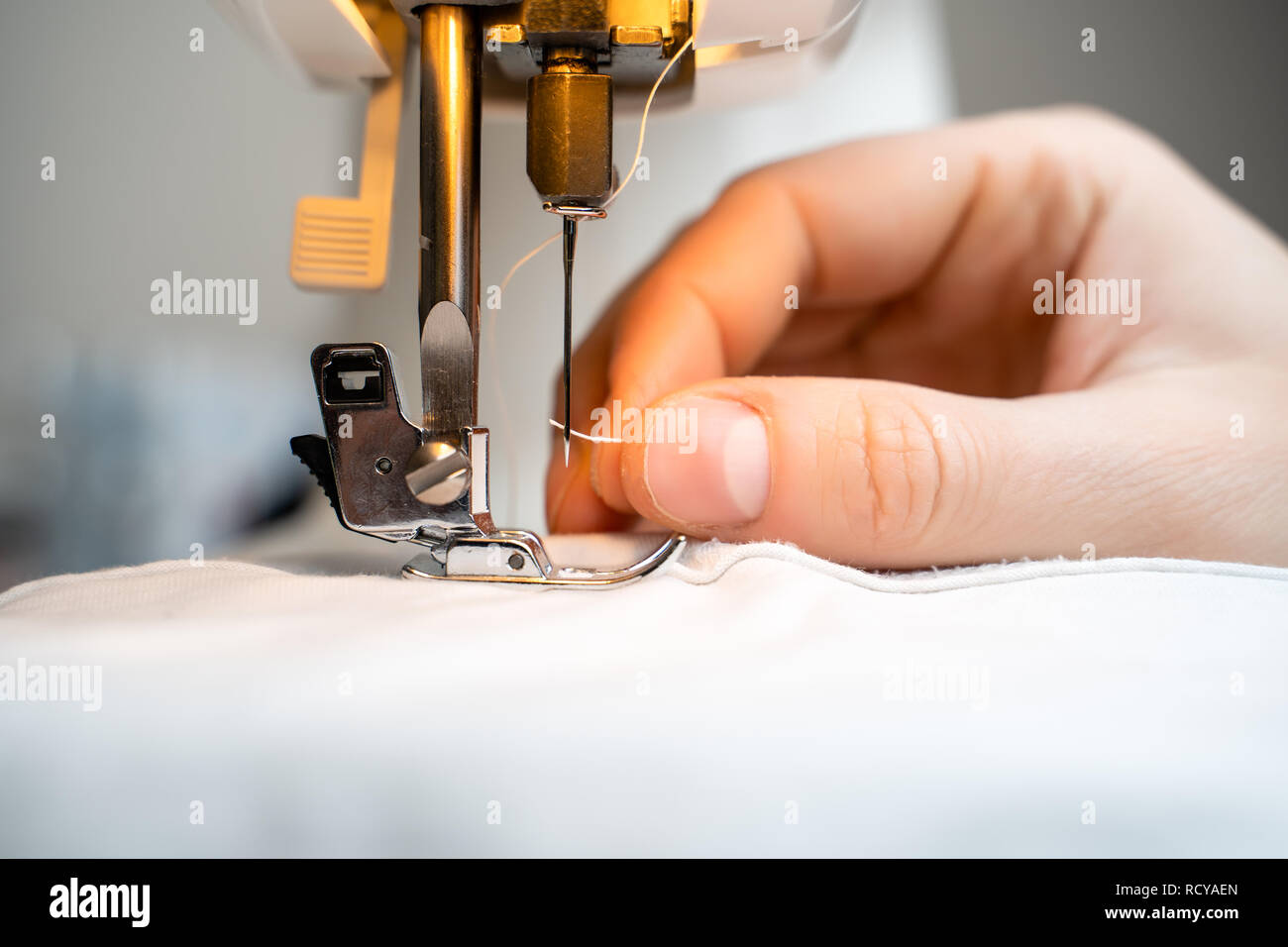 Closeup the sewing machine and item of clothing Stock Photo - Alamy