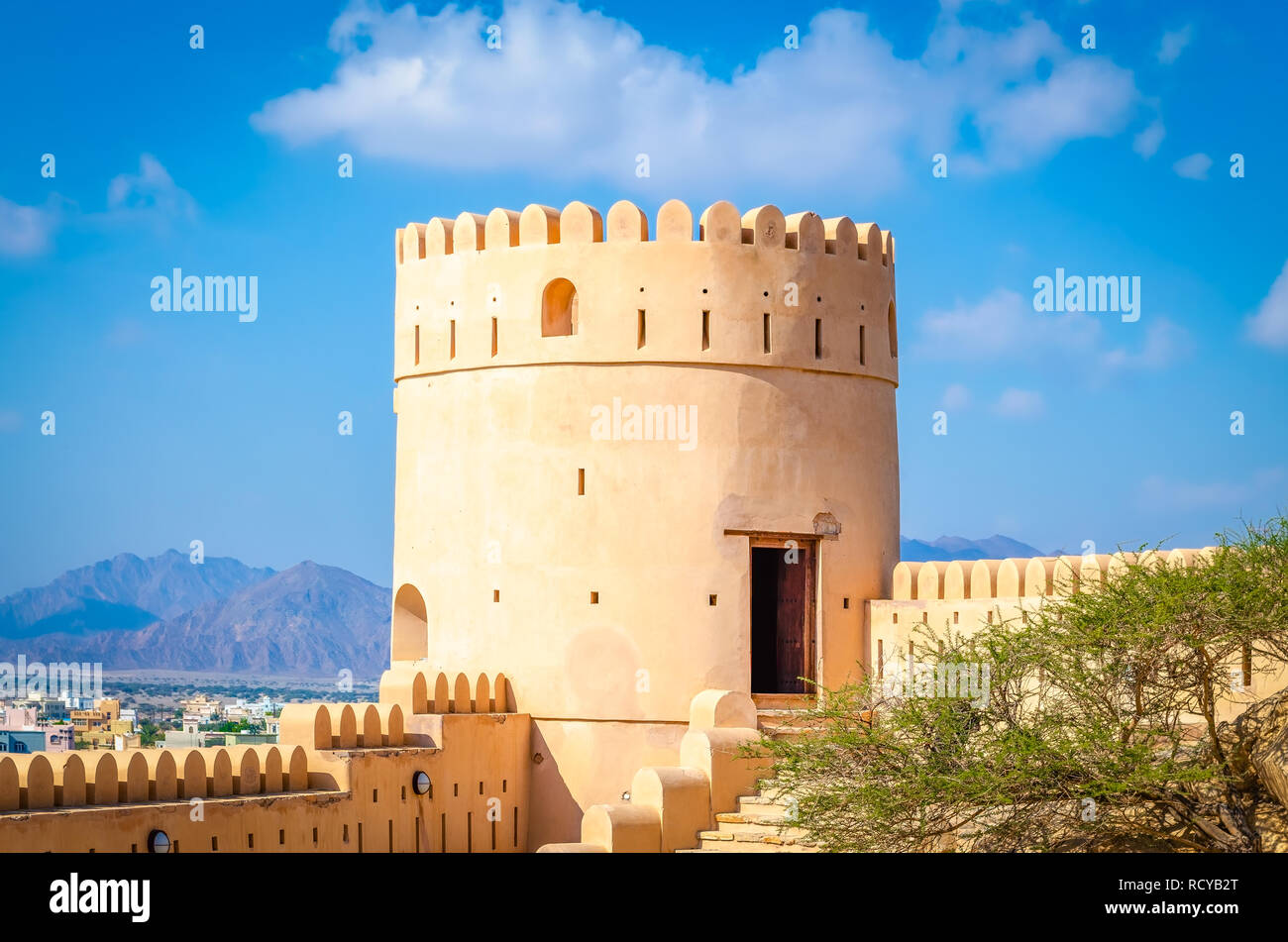 Tower of an old fort from Nakhal, Muscat, Oman. Mountains and a small ...