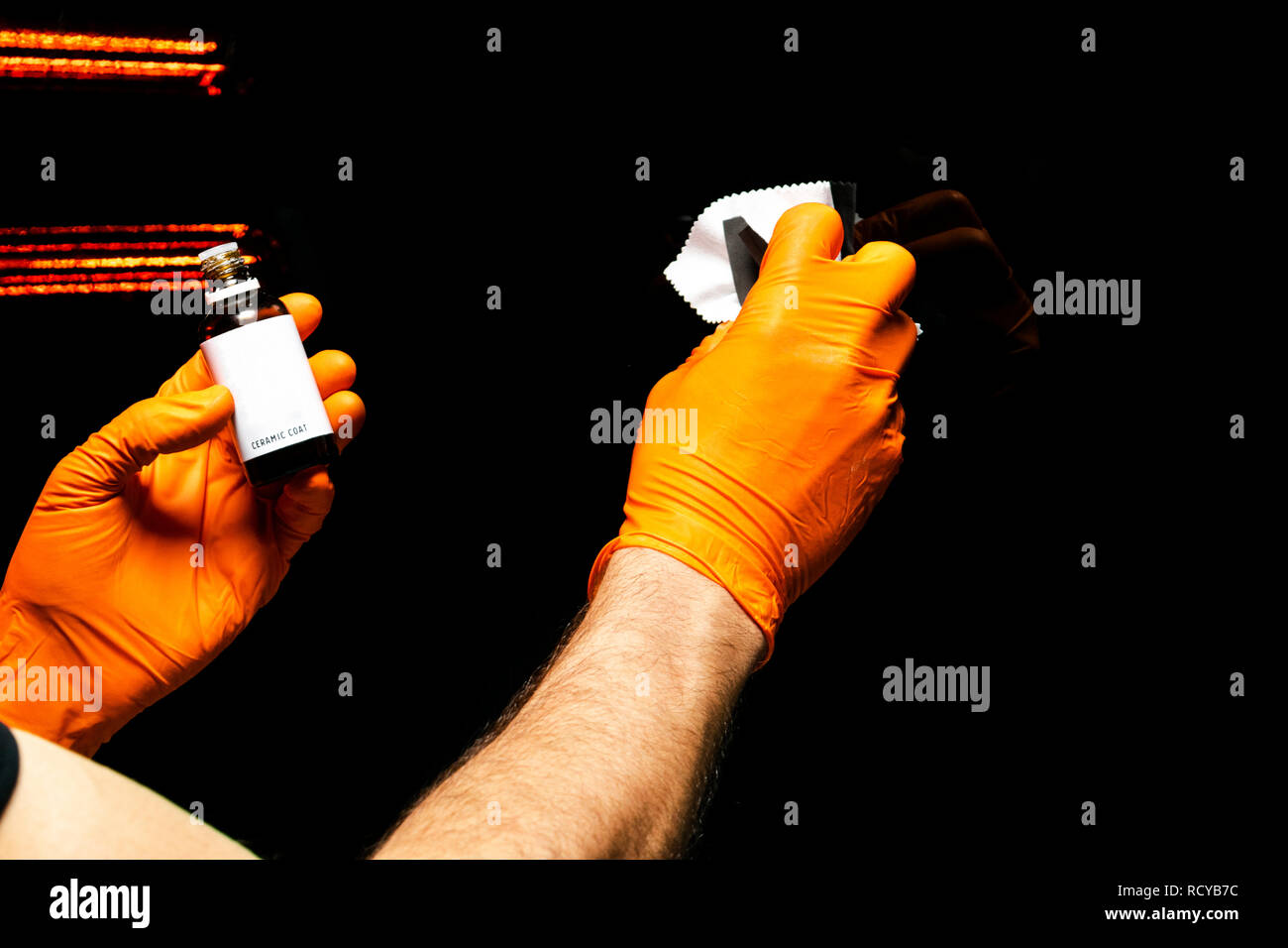 Car polish wax worker hands polishing car. Buffing and polishing ...
